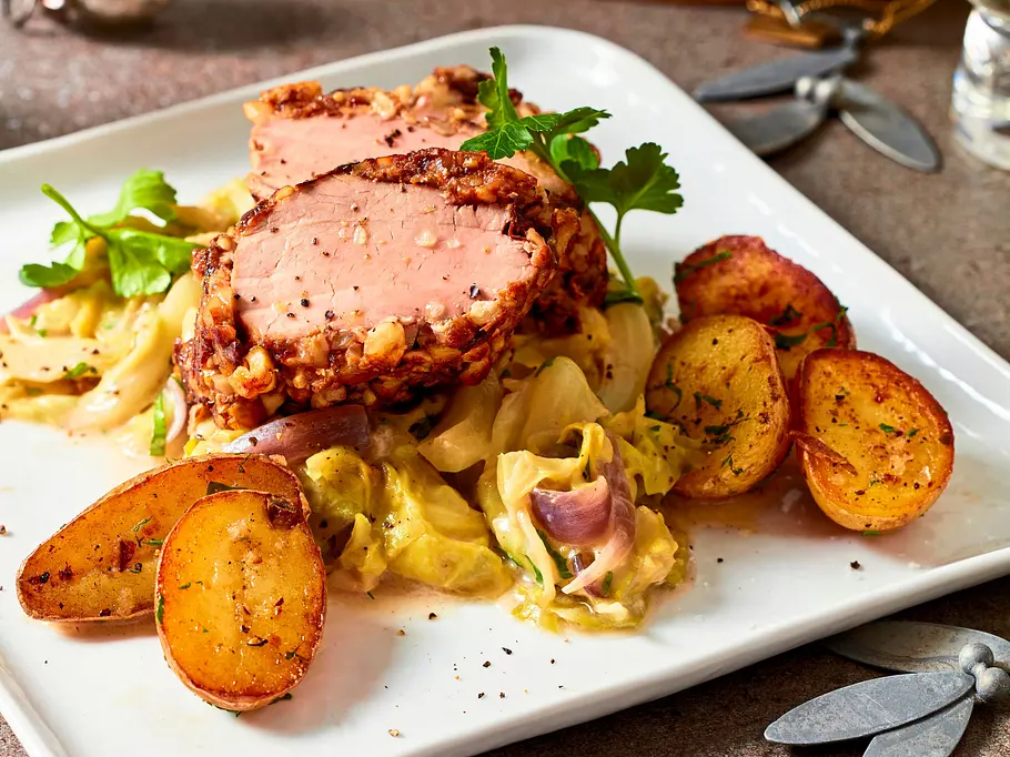 Schweinefilet mit Pflaumen-Nuss-Kruste und Rahm-Spitzkohl Rezept | LECKER